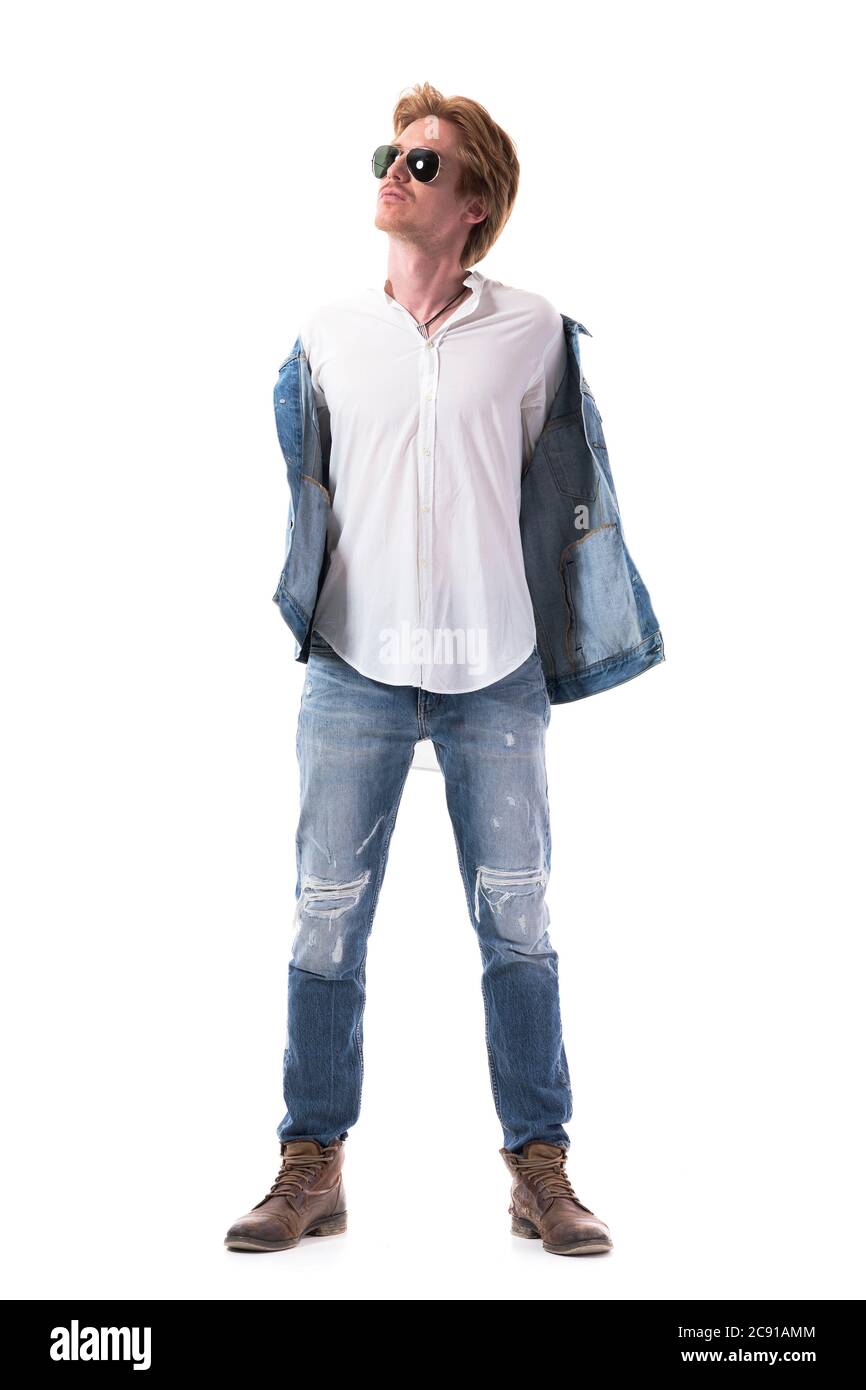 Handsome stylish young man removing jeans jacket taking off clothes ...