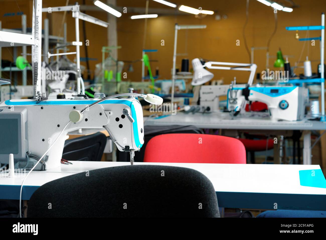 Sewing department of a textile factory interior Stock Photo - Alamy