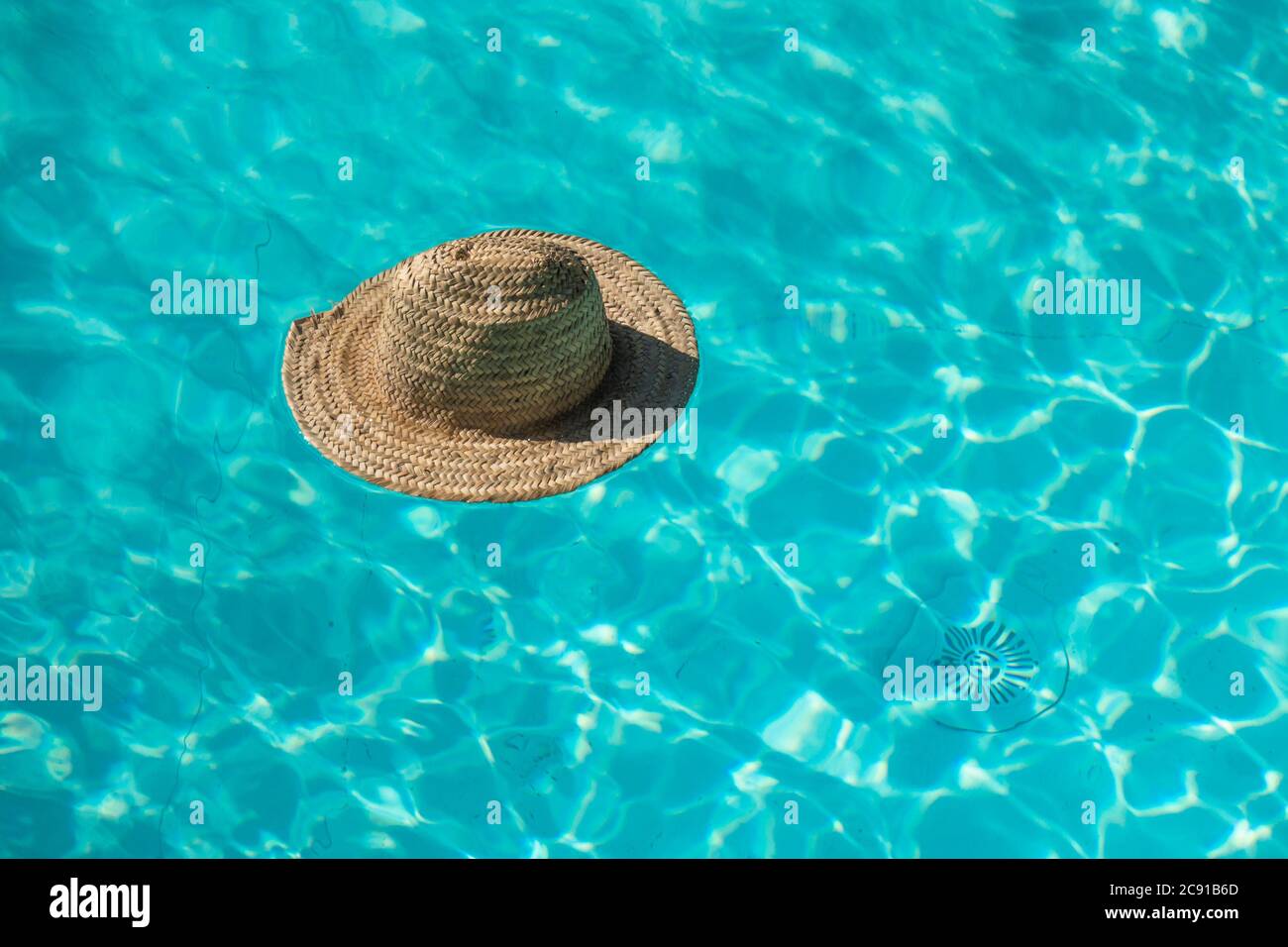 A straw hat floating in a blue pool, Spain Stock Photo - Alamy