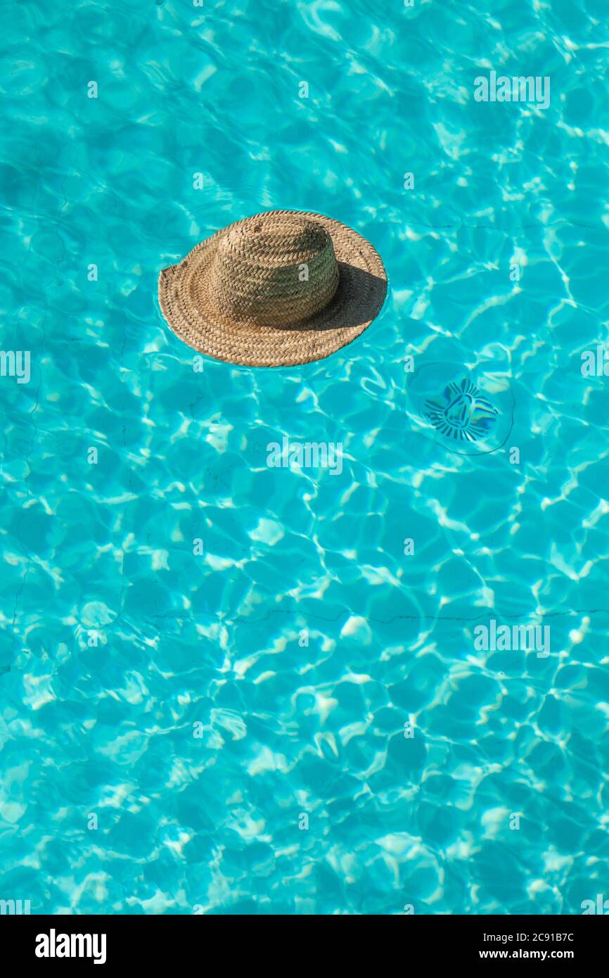 A straw hat floating in a blue pool, Spain Stock Photo - Alamy