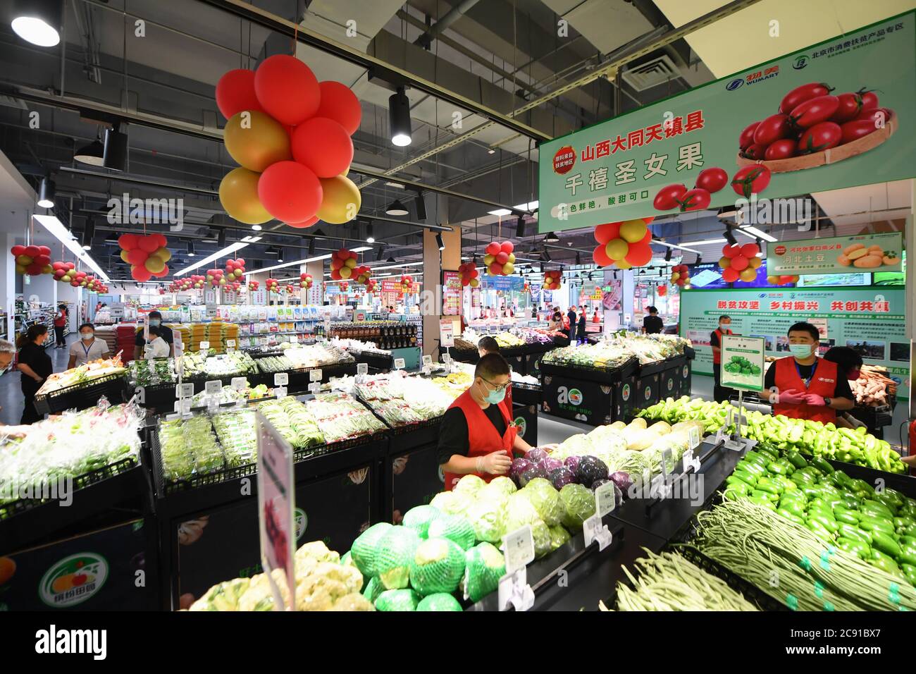 Beijing, China. 28th July, 2020. Staff members arrange goods at a ...