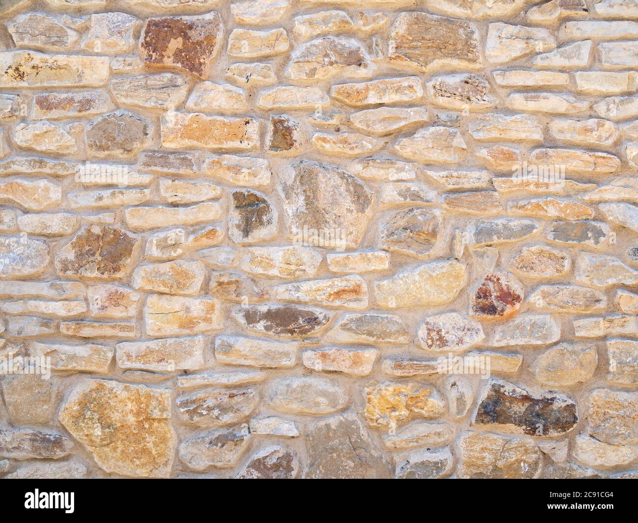 Real antique spanish rubble wall background texture Stock Photo - Alamy