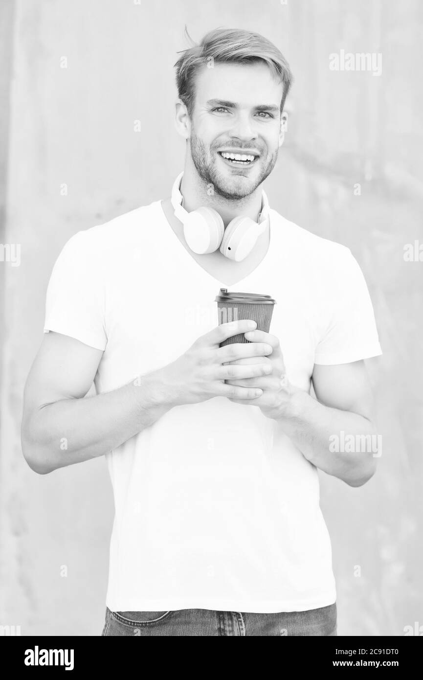 He needs caffeine energy. Happy guy hold takeaway cup outdoors ...