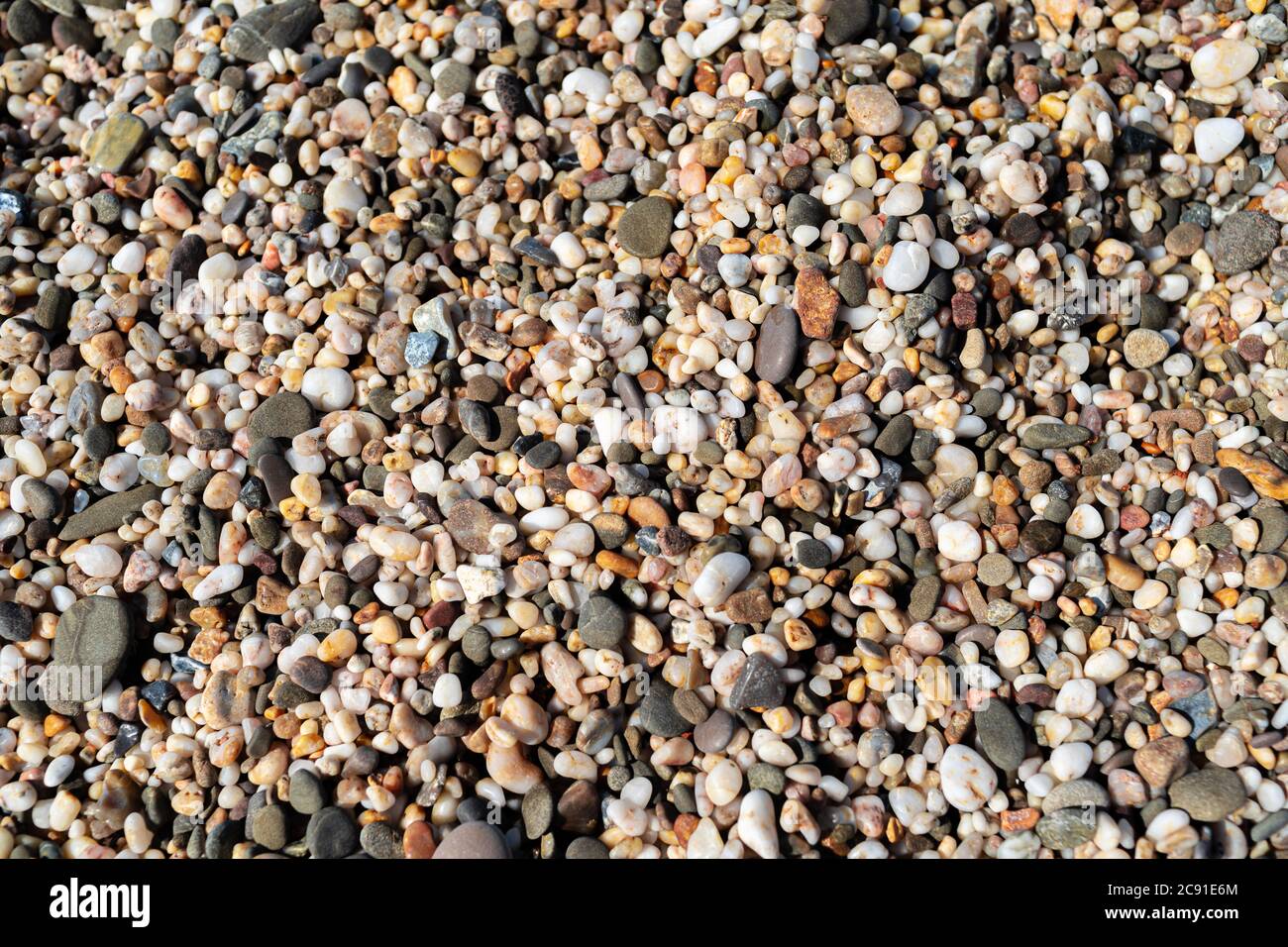 Small pebbles on the beach. Sea stones background Stock Photo - Alamy