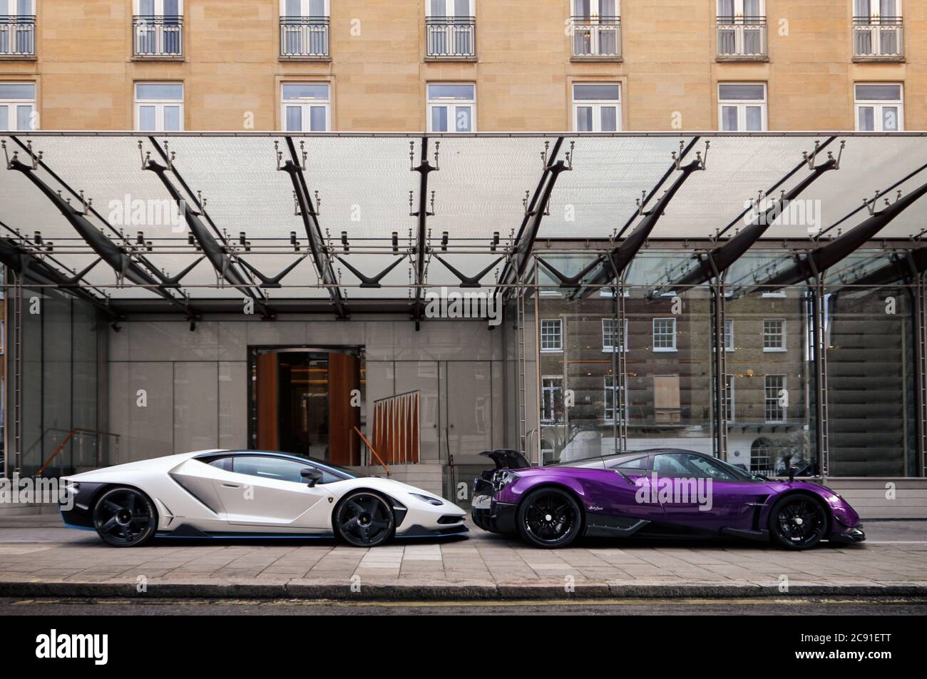 Two modern unique supercars, white Lamborghini Centenario and purple ...