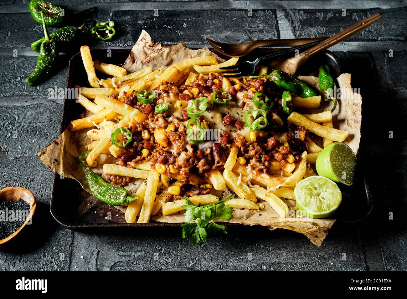 Fried potato chips topped with beef mince, fresh spicy chili peppers ...