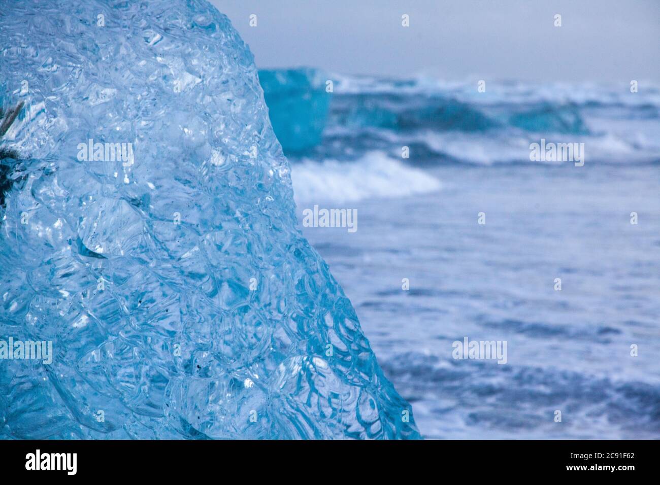 A famous beach in Iceland with a lot pieces of ice on the sand that ...