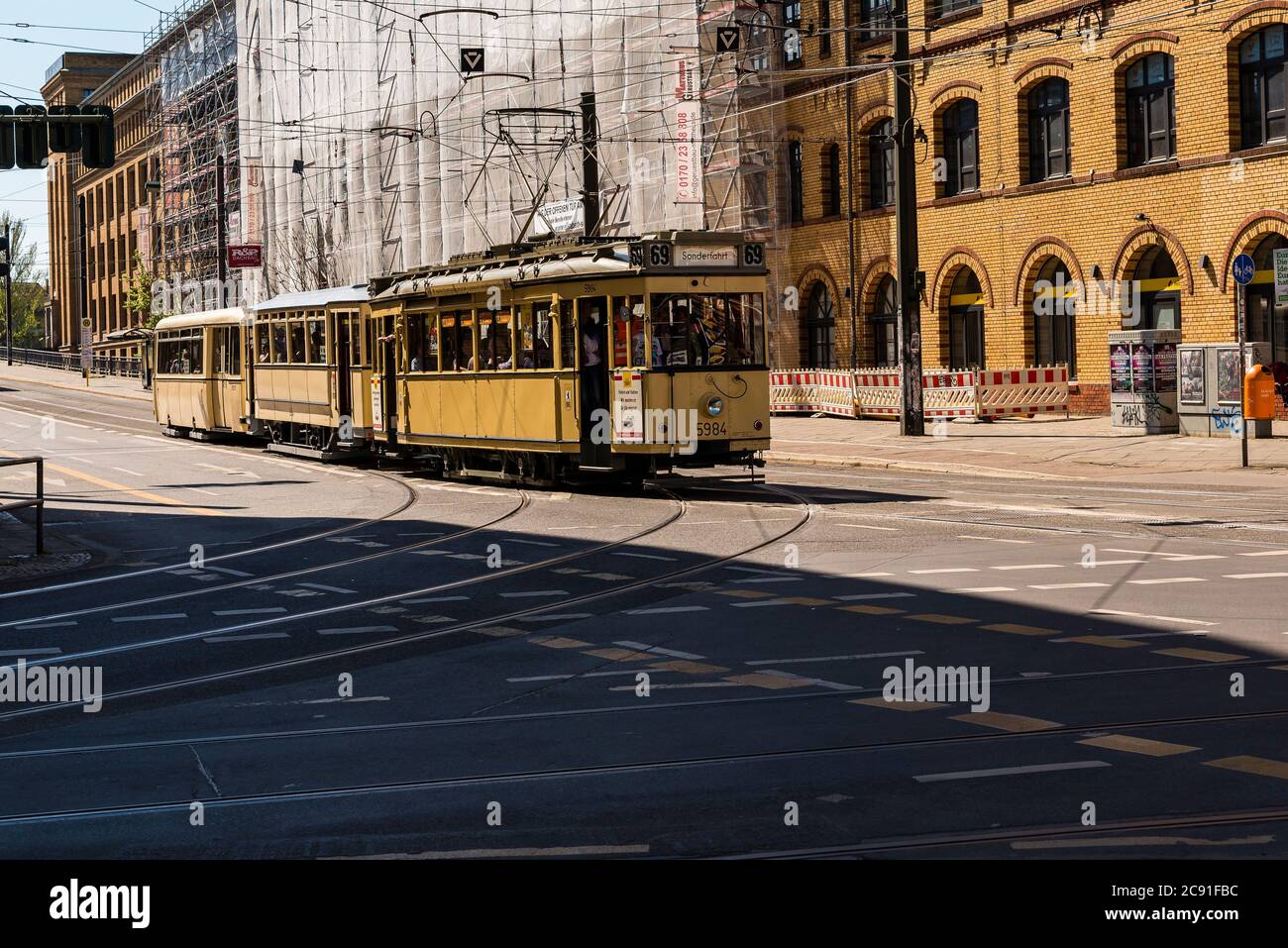 An old historical tram crossing an intersection, old tram in Berlin ...