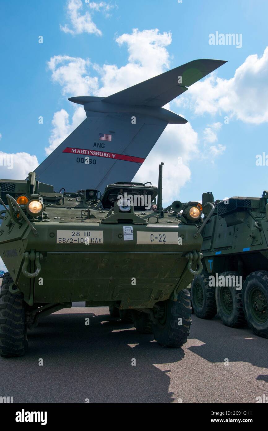 A group of Strykers are unloaded from a jumbo C-5 Air Force plane flown ...