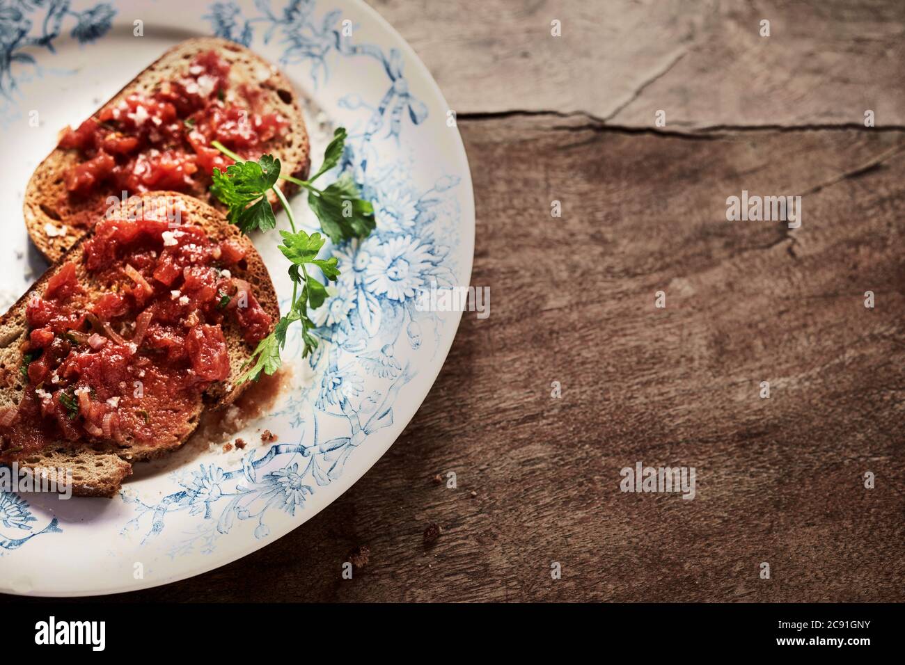 Spanish tapas with tomato and chili topping on sliced fresh bread ...