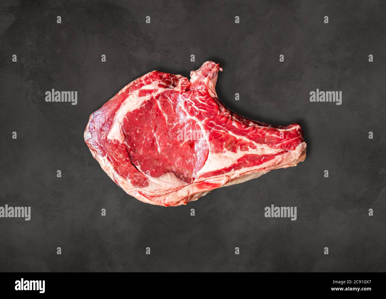 Raw beef prime rib on a concrete background. Top view Stock Photo - Alamy