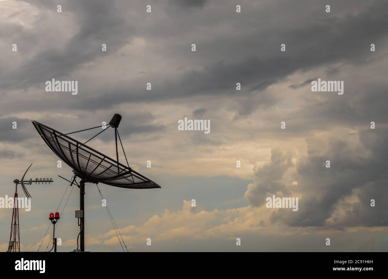 Black Satellite Dish Antenna Receiver Against on Blue Sky background ...