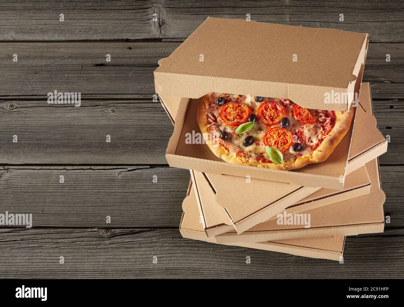 Delicious traditional Italian pizzas in brown unlabelled takeaway boxes ...