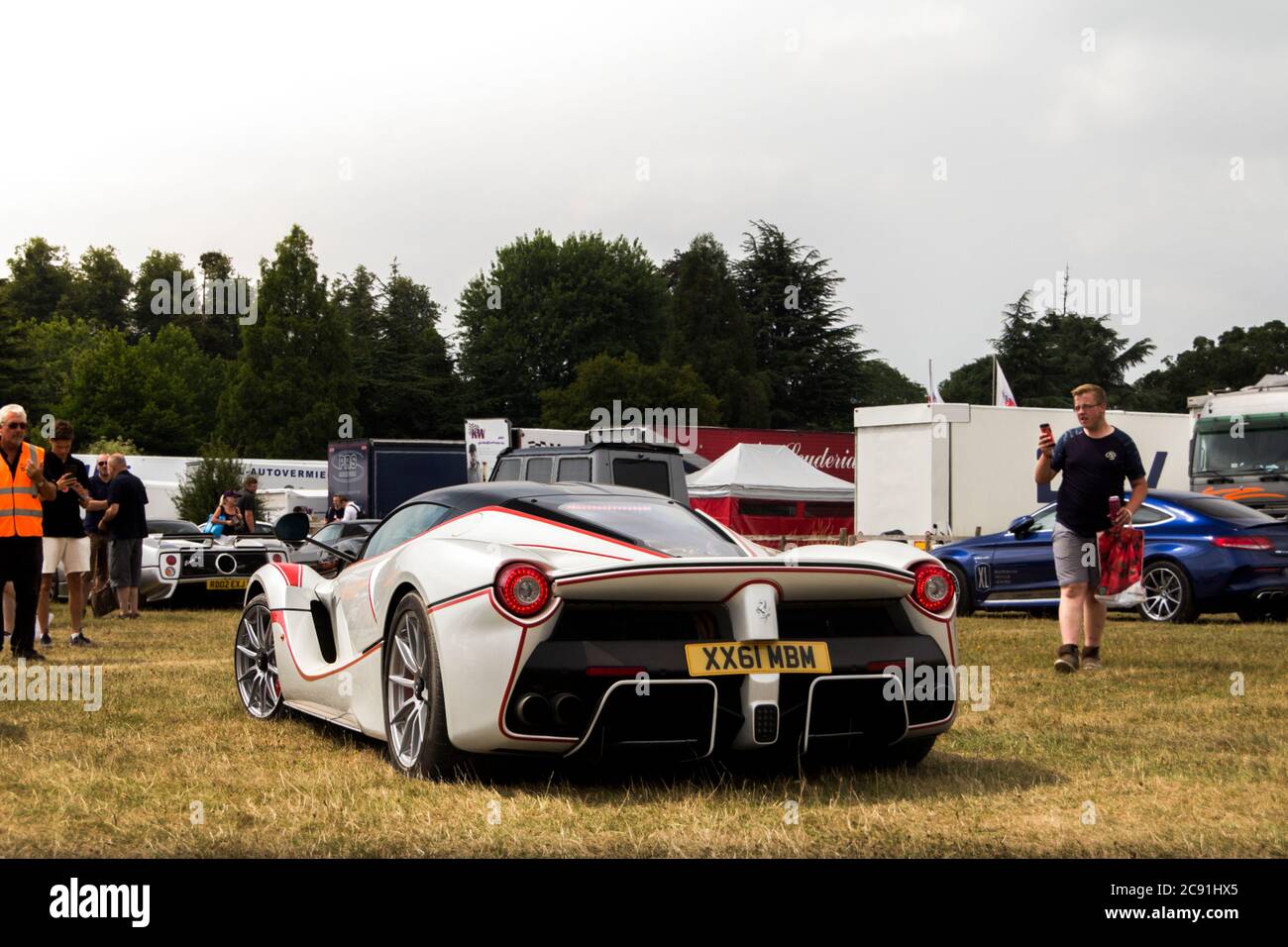 White Ferrari LaFerrari supercar with red pinstripes arriving to a ...