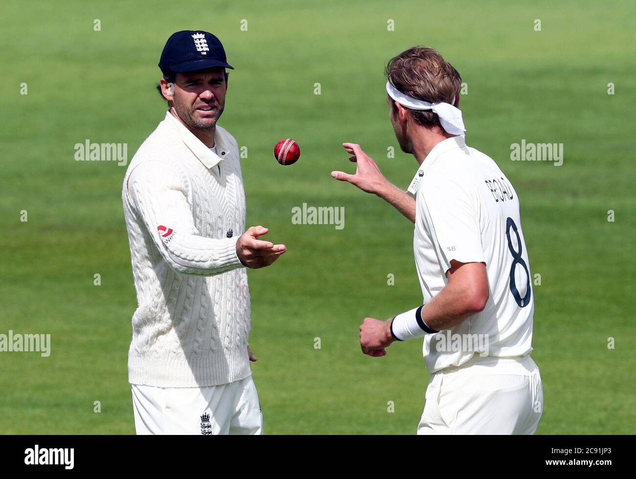 England's James Anderson (left) passes the ball to Stuart Broad during ...