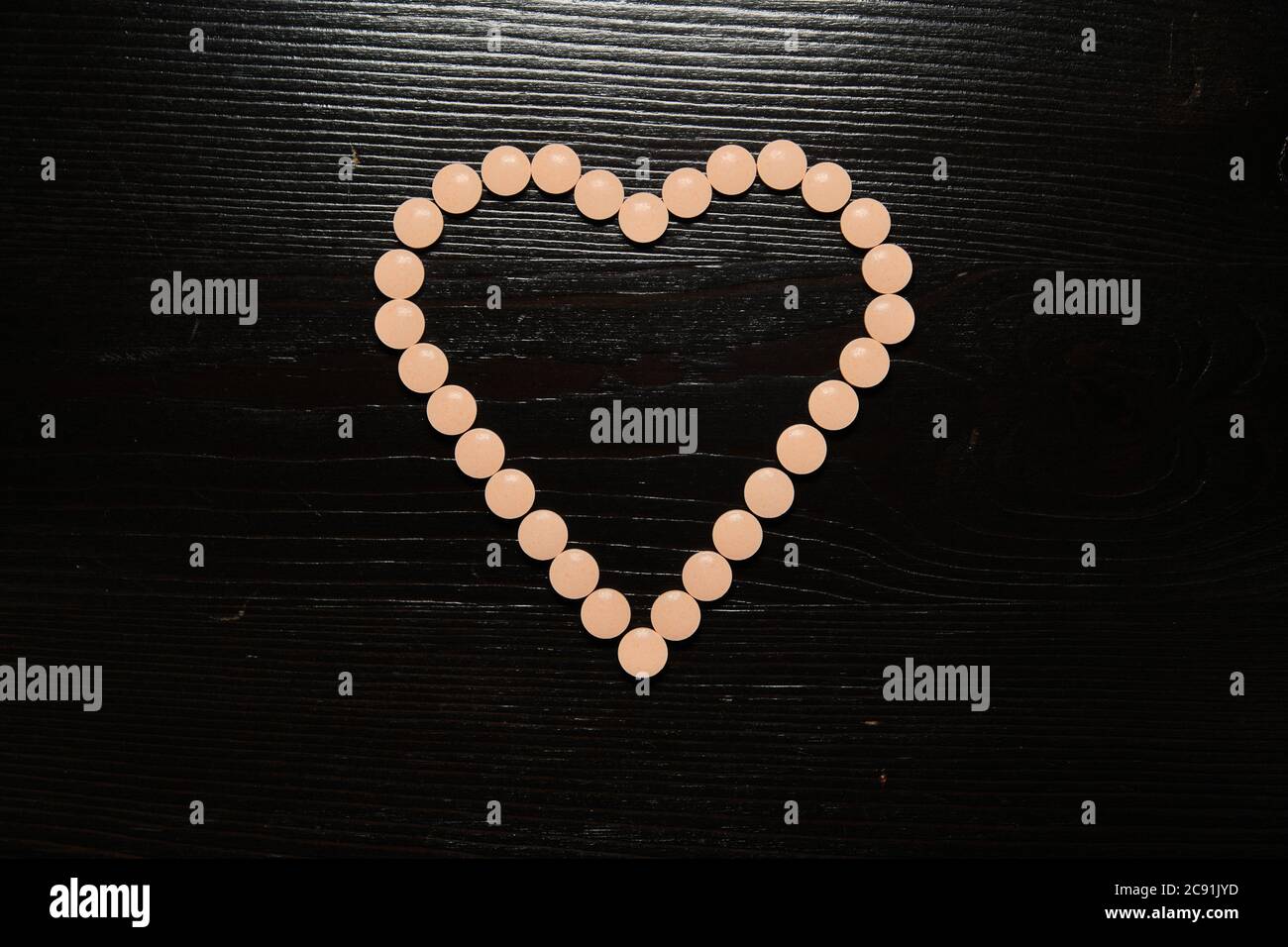 High angel shot of a light orange pills formed into the shape of a ...