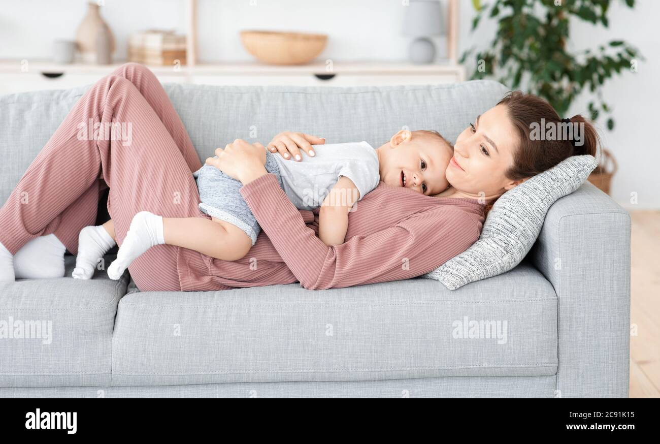Boy lying couch mother hi-res stock photography and images - Alamy