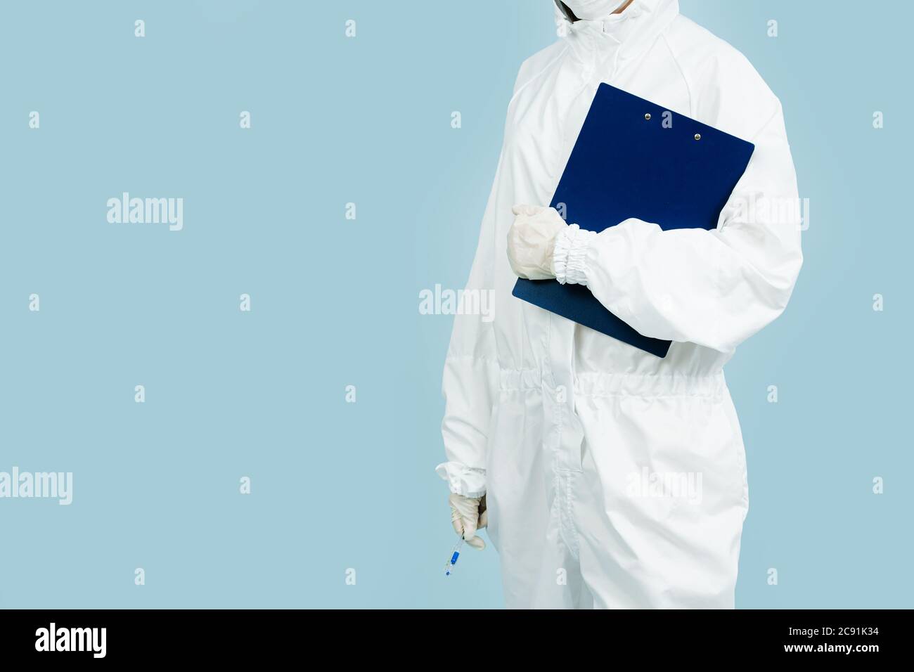 Doctor with the folder in hand over blue background. Cropped. No head ...