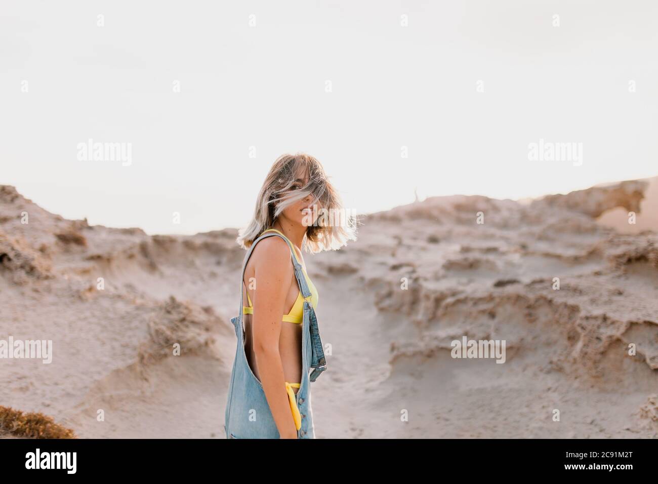 Woman in the beach wearing yellow swimsuit Stock Photo - Alamy