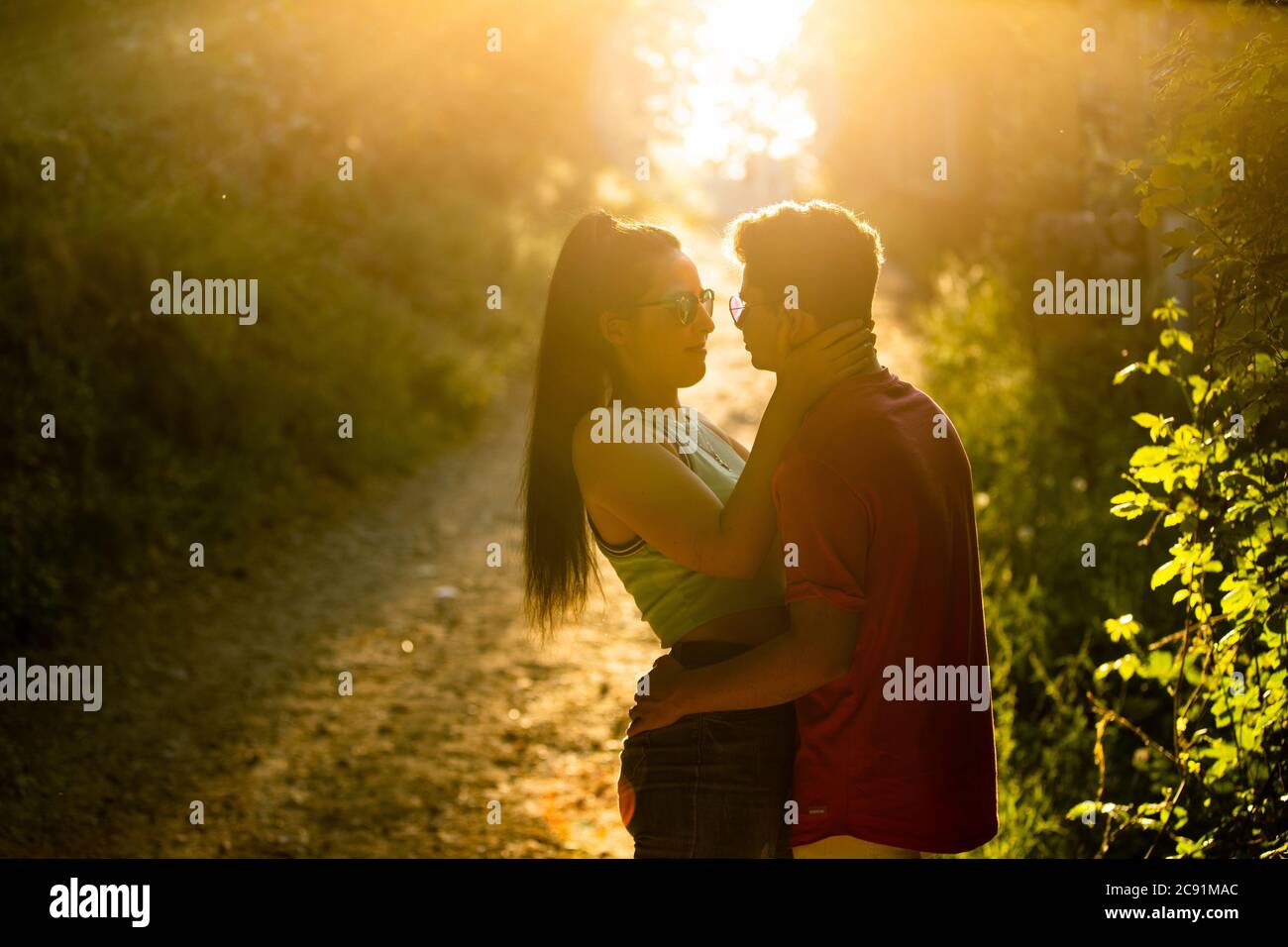 Romantic shot of a couple hugging each other gently and looking each ...