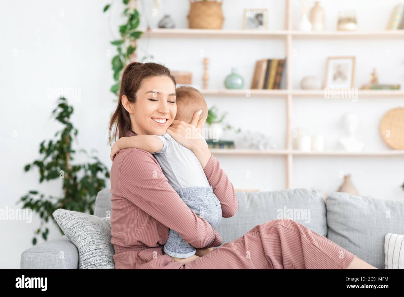 Mother-Child Connection. Happy Mom Hugging Her Toddler Baby While ...