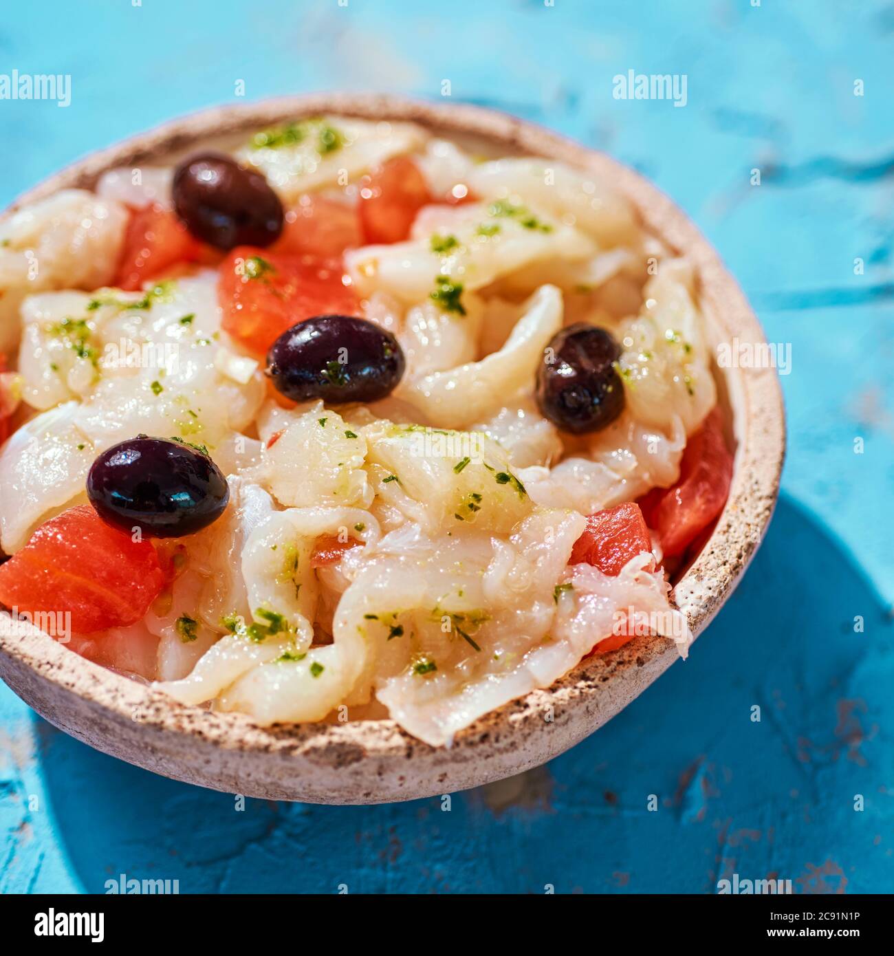 closeup of a plate with esqueixada de bacalla, a cold dish made with ...