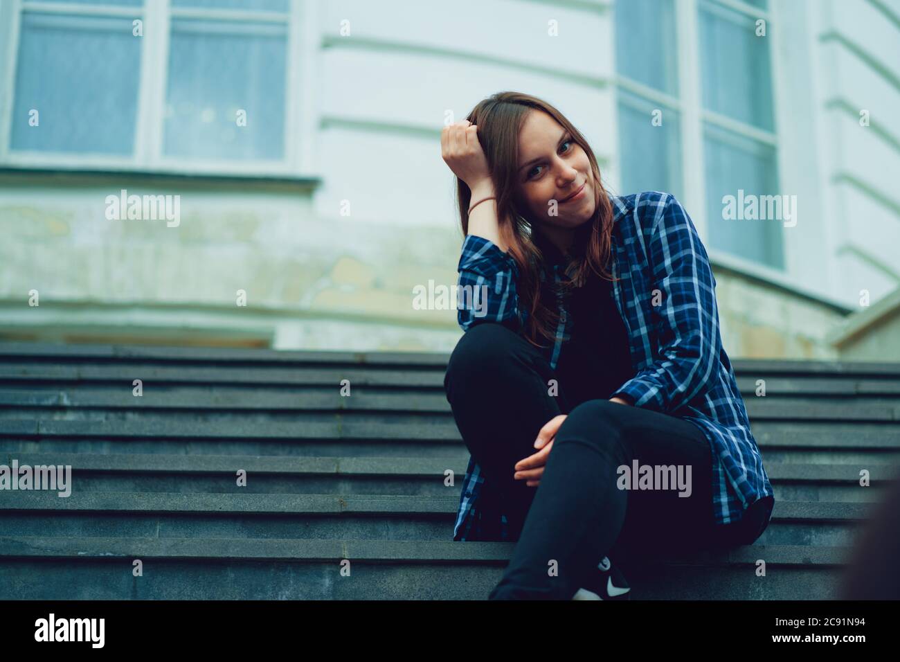 Young pretty woman poses on stairs of manor. Adult smiley female ...