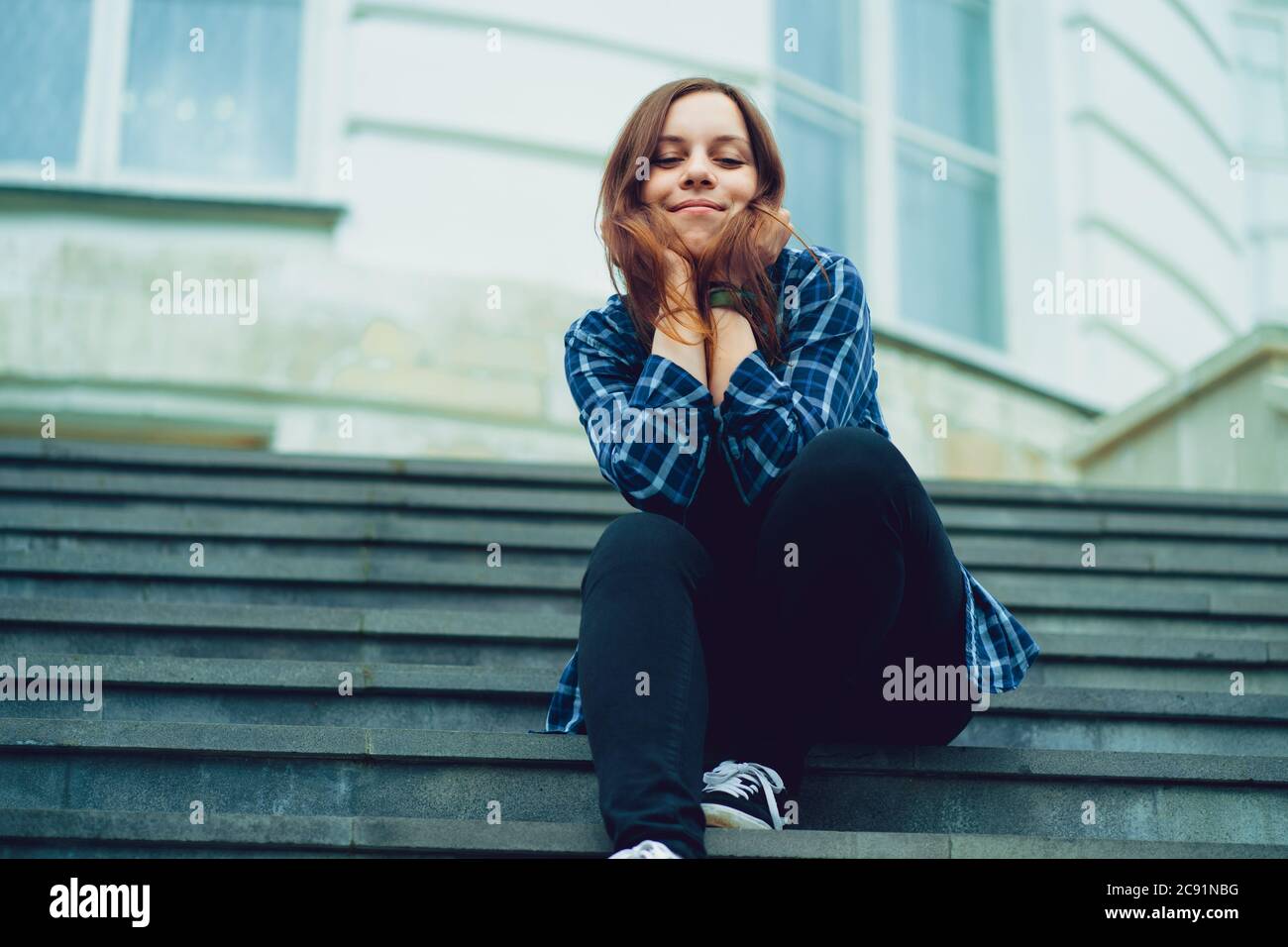 Young pretty woman poses on stairs of manor. Adult smiley female ...
