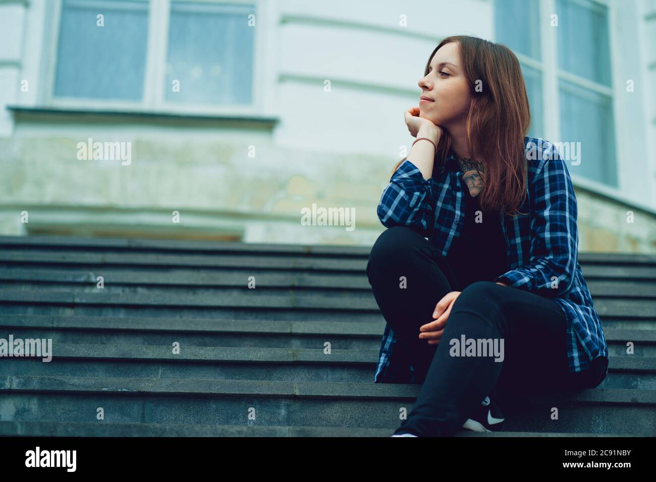 Young pretty woman poses on stairs of manor. Adult smiley female ...