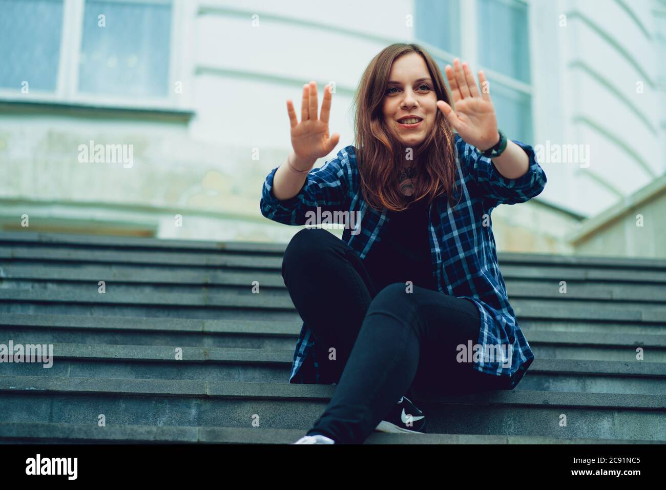 Young pretty woman poses on stairs of manor. Adult smiley female ...