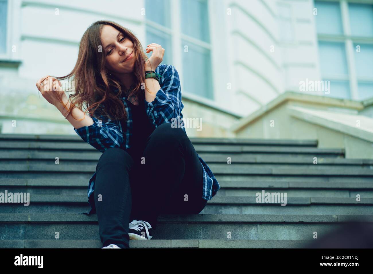 Young pretty woman poses on stairs of manor. Adult smiley female ...