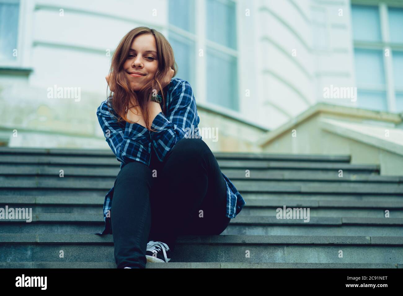 Young pretty woman poses on stairs of manor. Adult smiley female ...