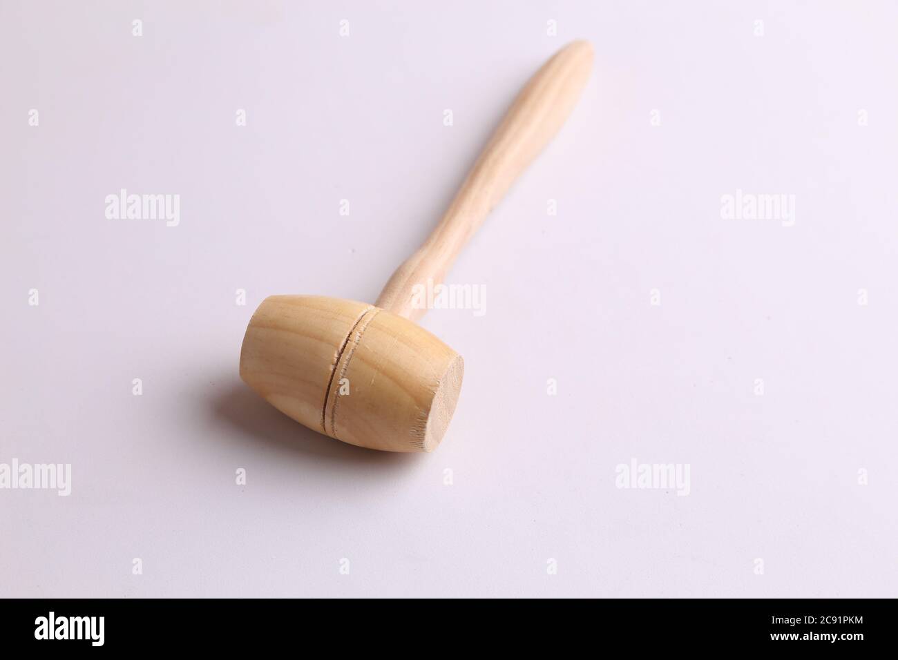 Closeup shot of a small wooden mallet isolated on a white background ...