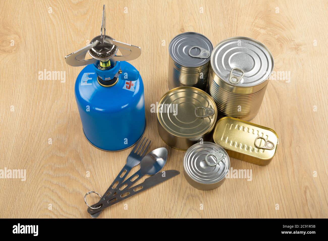 Picture of camping tools on a table - gas tank, cans, etc - ready to go ...
