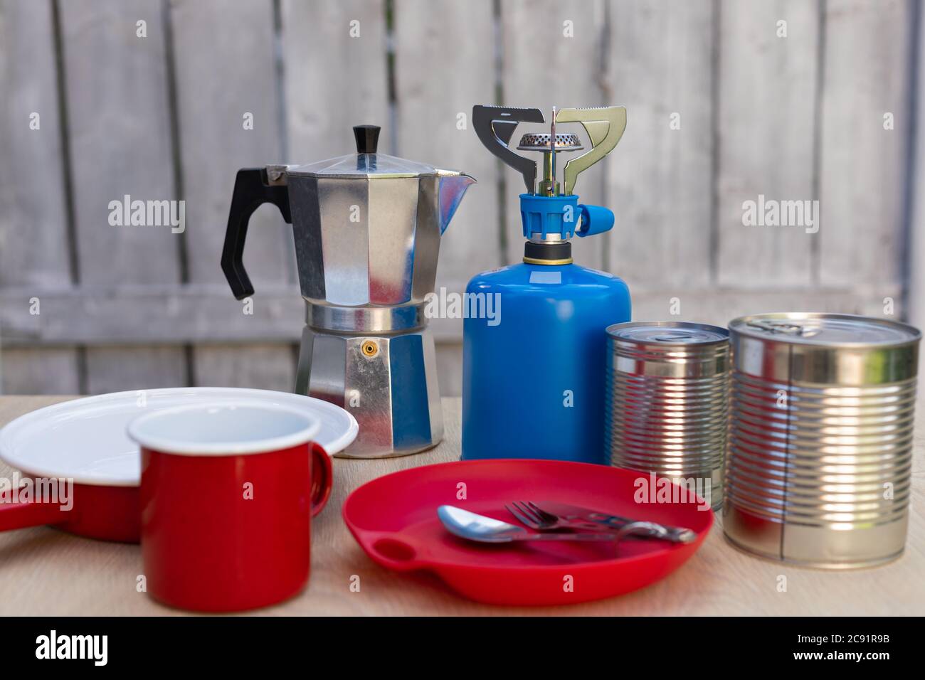 Picture of camping tools on a table - gas tank, cans, etc - ready to go ...