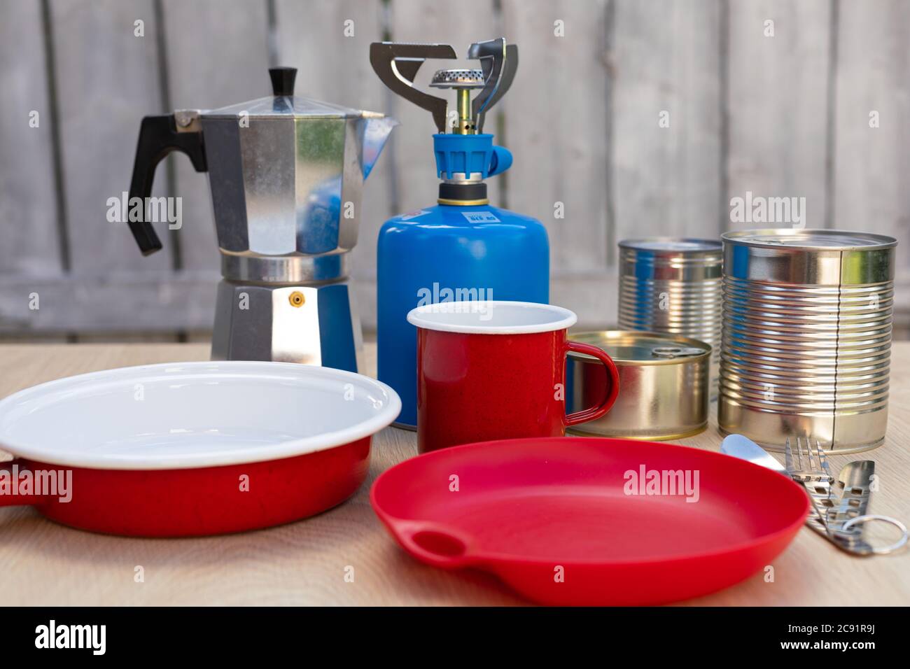 Picture of camping tools on a table - gas tank, cans, etc - ready to go ...