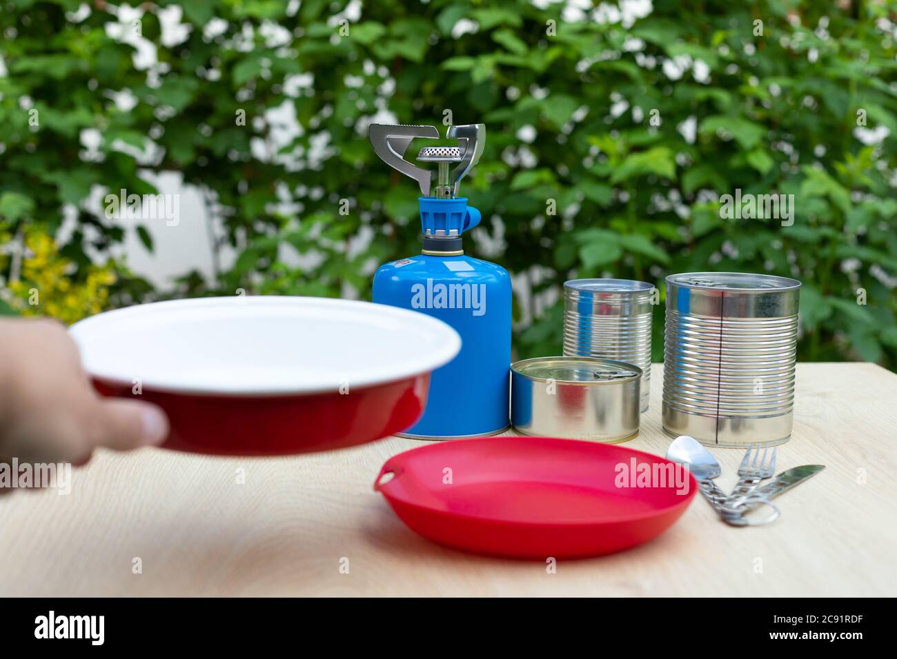 Picture of camping tools on a table - gas tank, cans, etc - ready to go ...