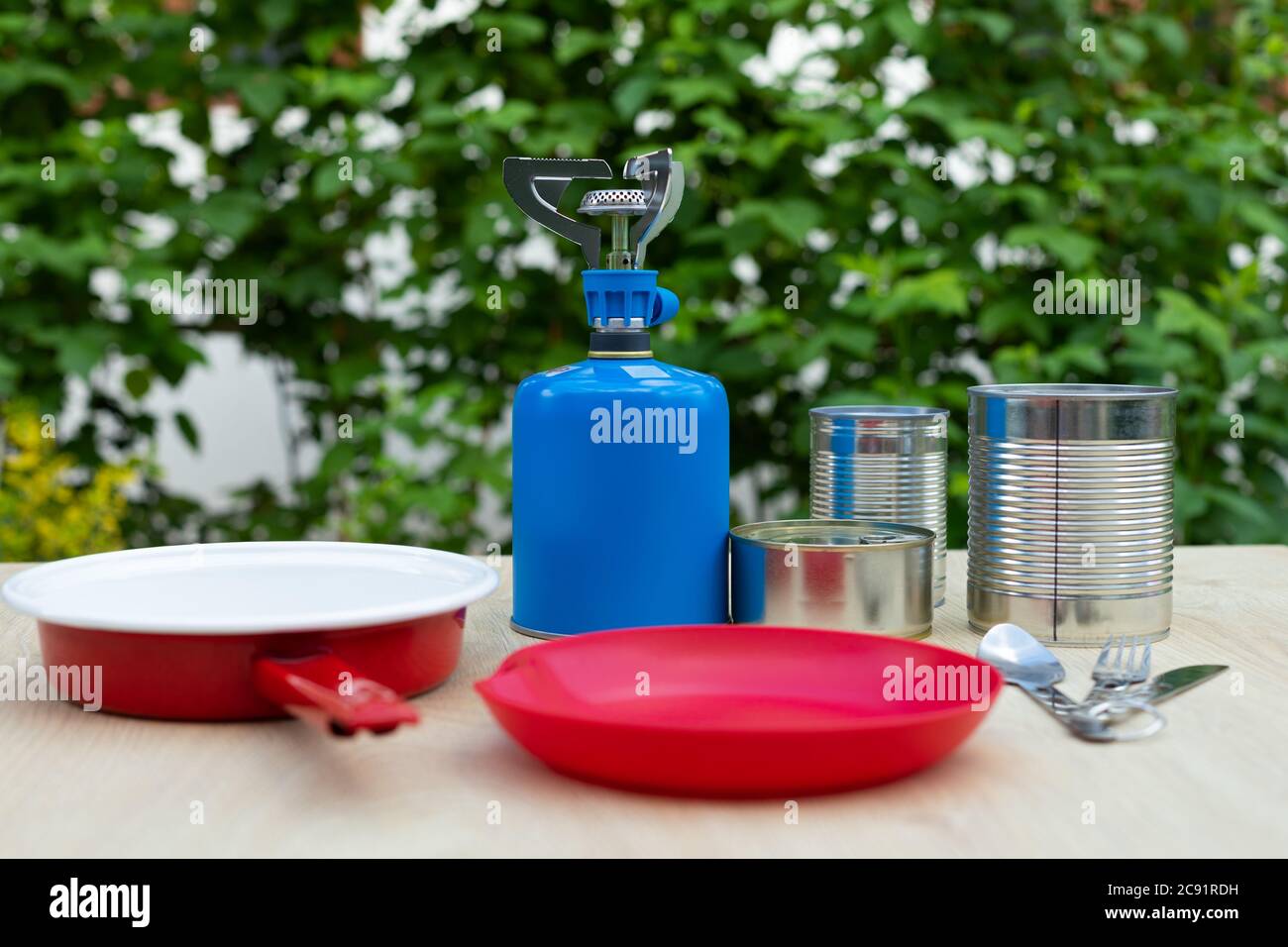 Picture of camping tools on a table - gas tank, cans, etc - ready to go ...