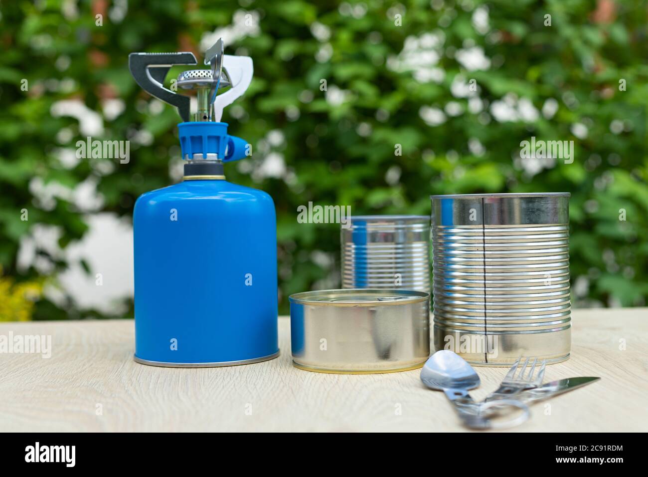 Picture of camping tools on a table - gas tank, cans, etc - ready to go ...