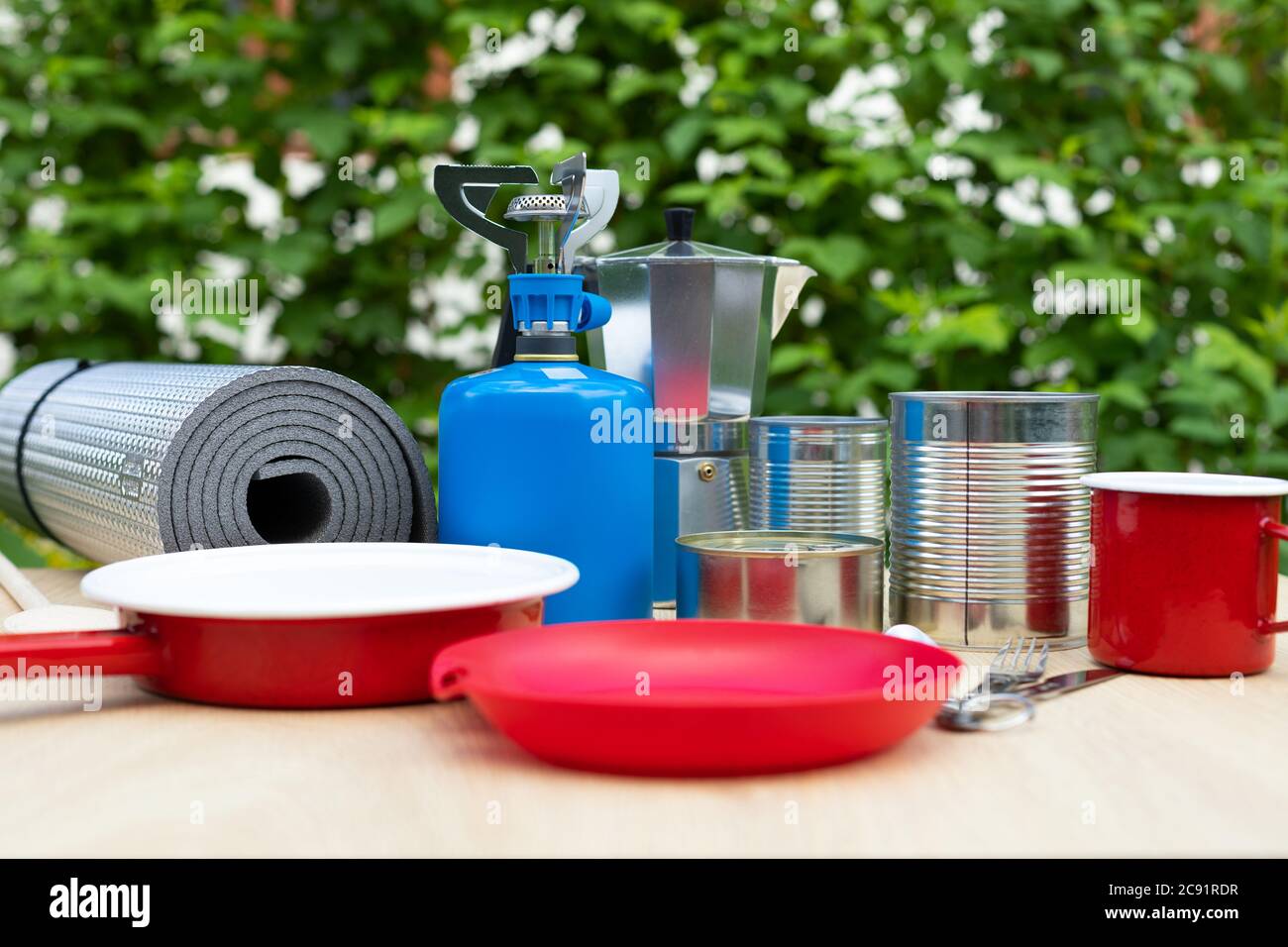 Picture of camping tools on a table - gas tank, cans, etc - ready to go ...