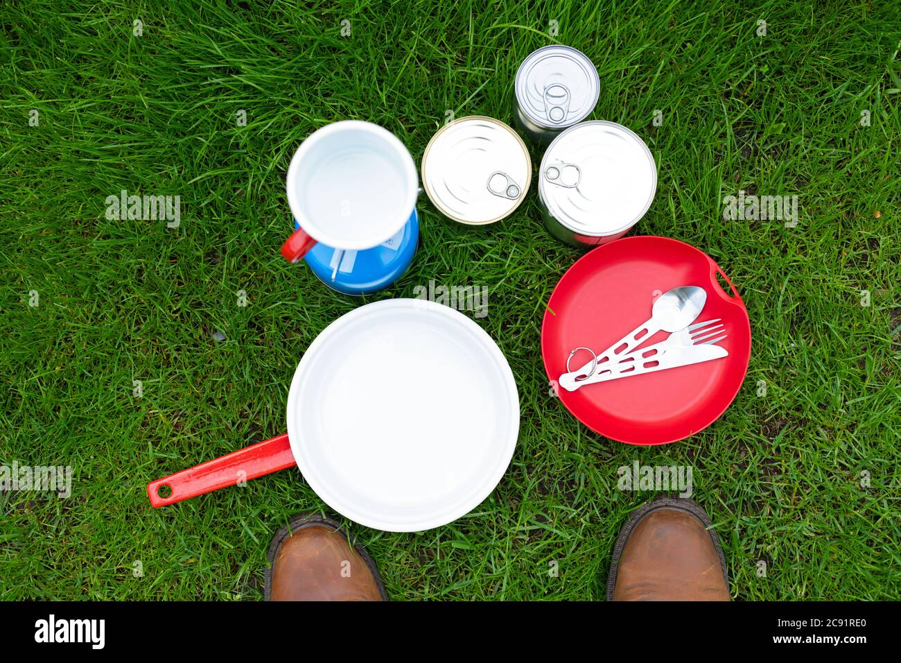 Picture of camping tools on the grass - backpack, tent, gas tank, cans ...