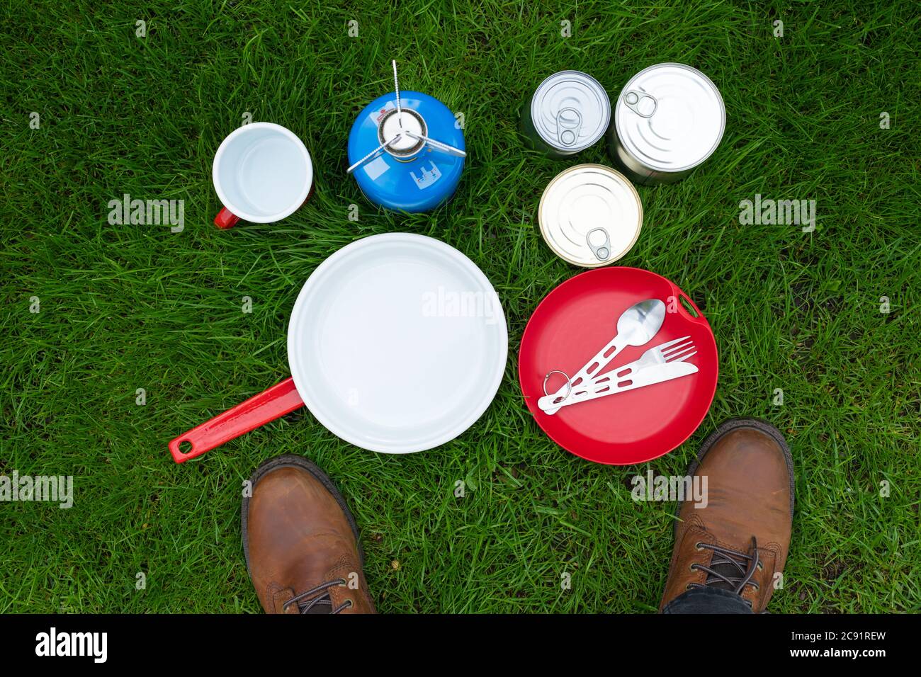 Picture of camping tools on the grass - backpack, tent, gas tank, cans ...