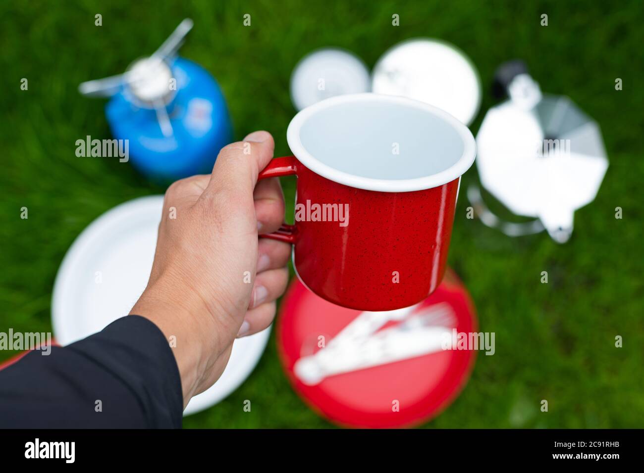 Picture of camping tools on the grass - backpack, tent, gas tank, cans ...