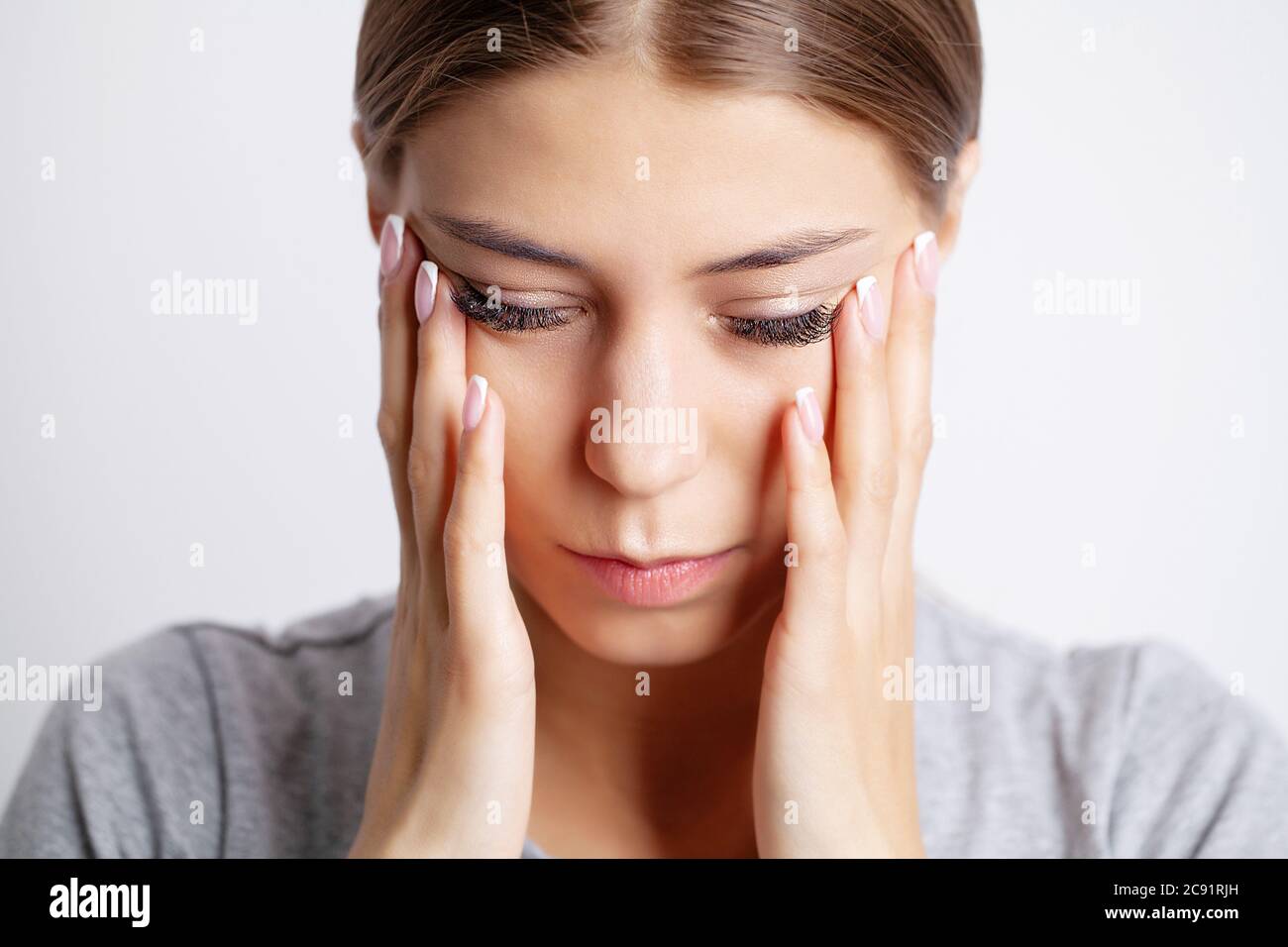 Pretty girl feels severe pain around the eyes Stock Photo - Alamy