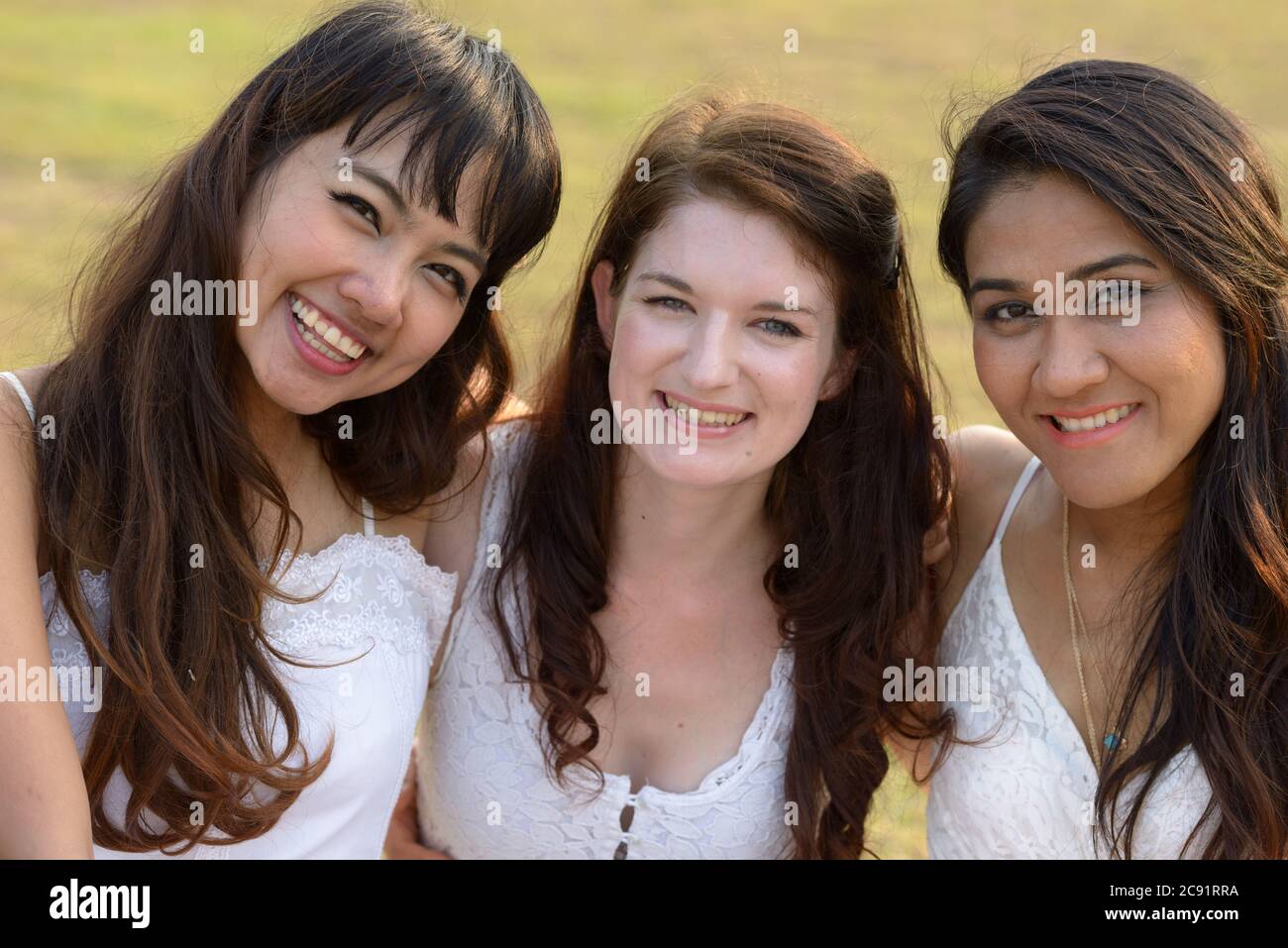 Three multi ethnic young beautiful women as friends together in the ...