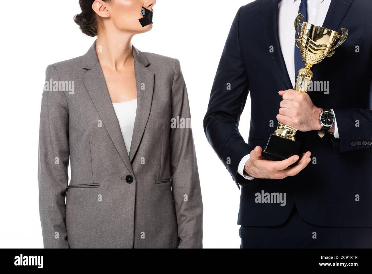 partial view of businessman holding golden trophy near businesswoman ...