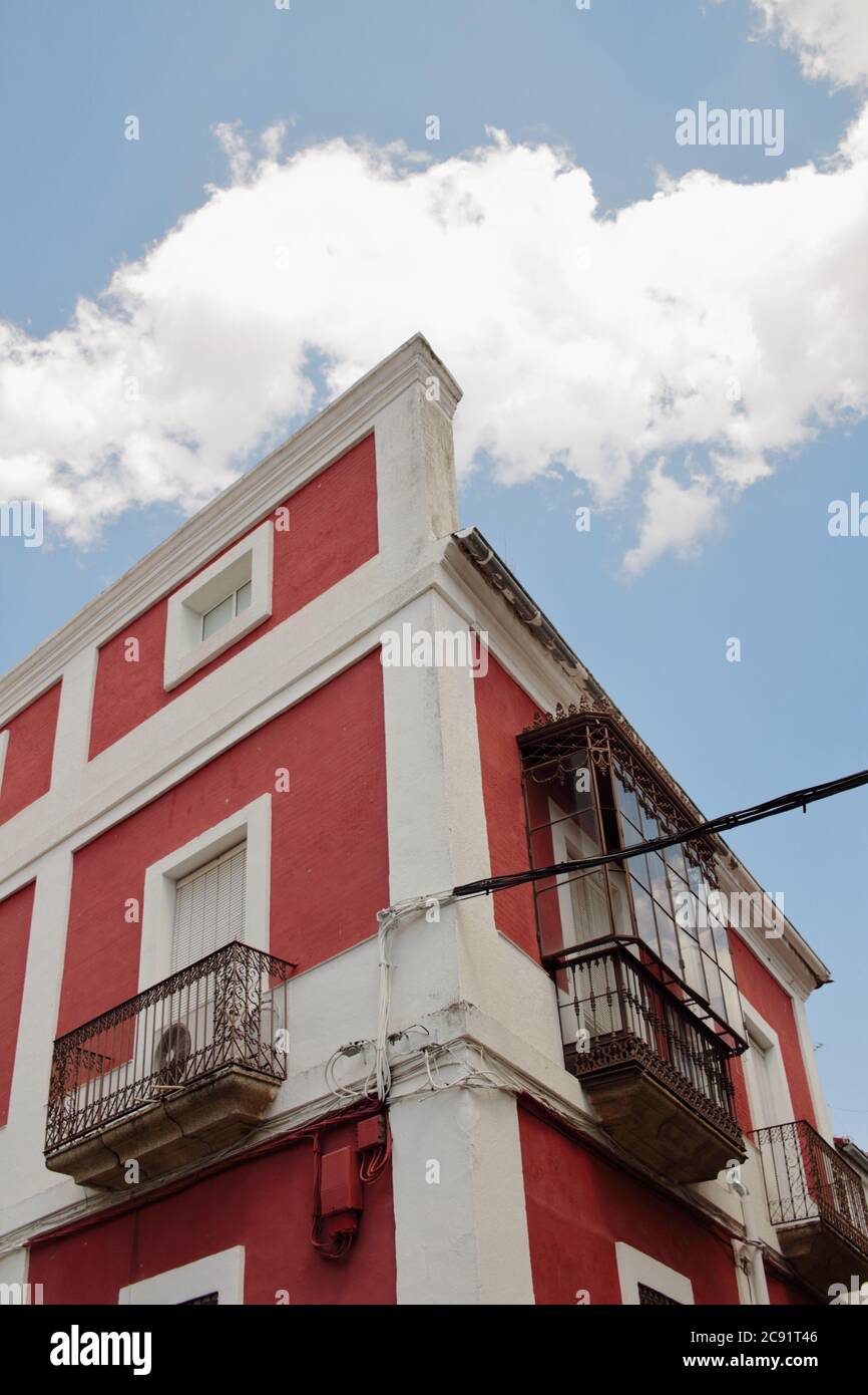 Low angle shot of a facade of a white and red building under a cloudy ...