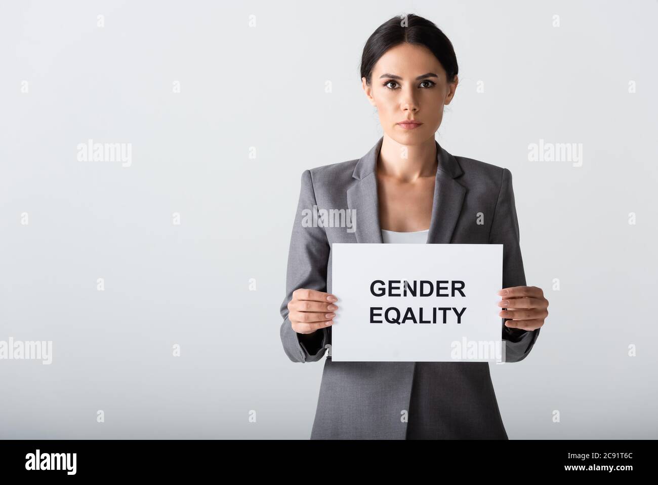 attractive businesswoman holding placard with gender equality lettering ...