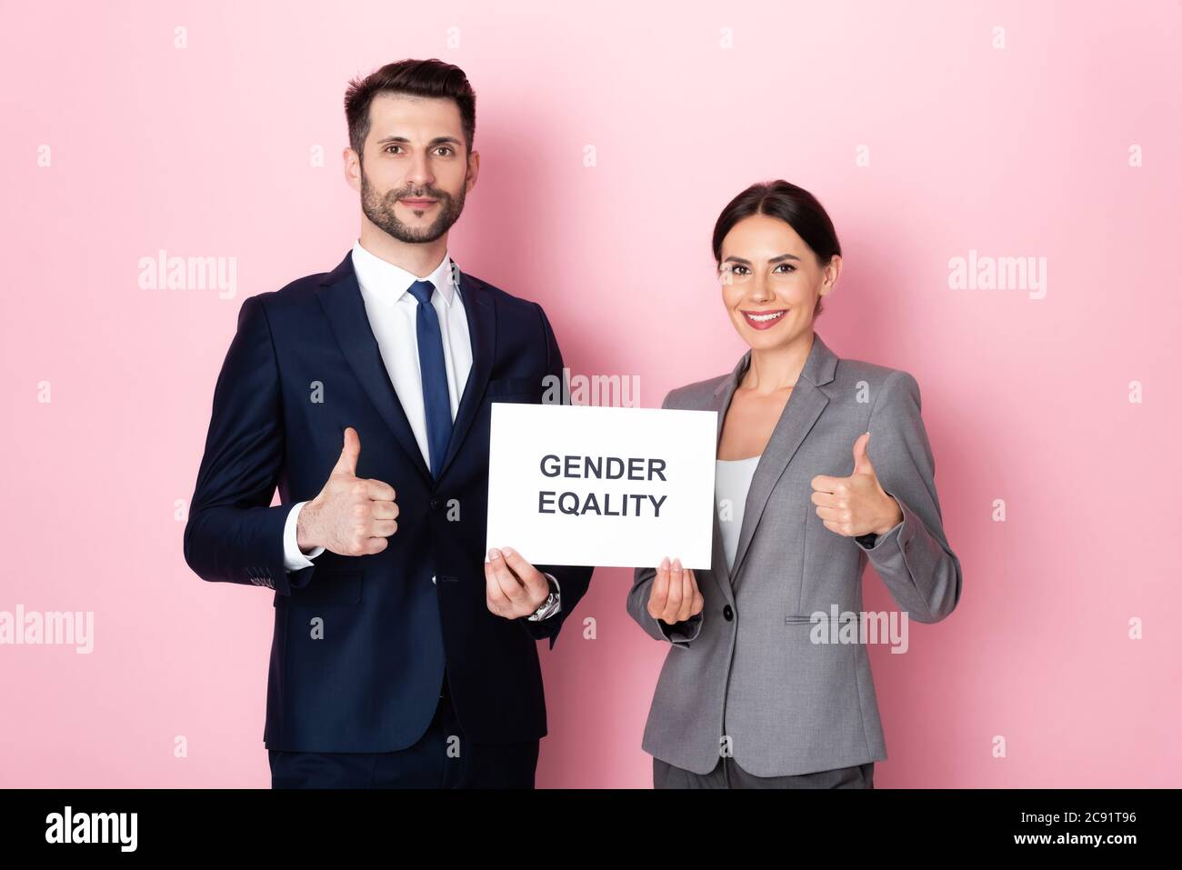 handsome businessman and businesswoman holding placard with gender ...