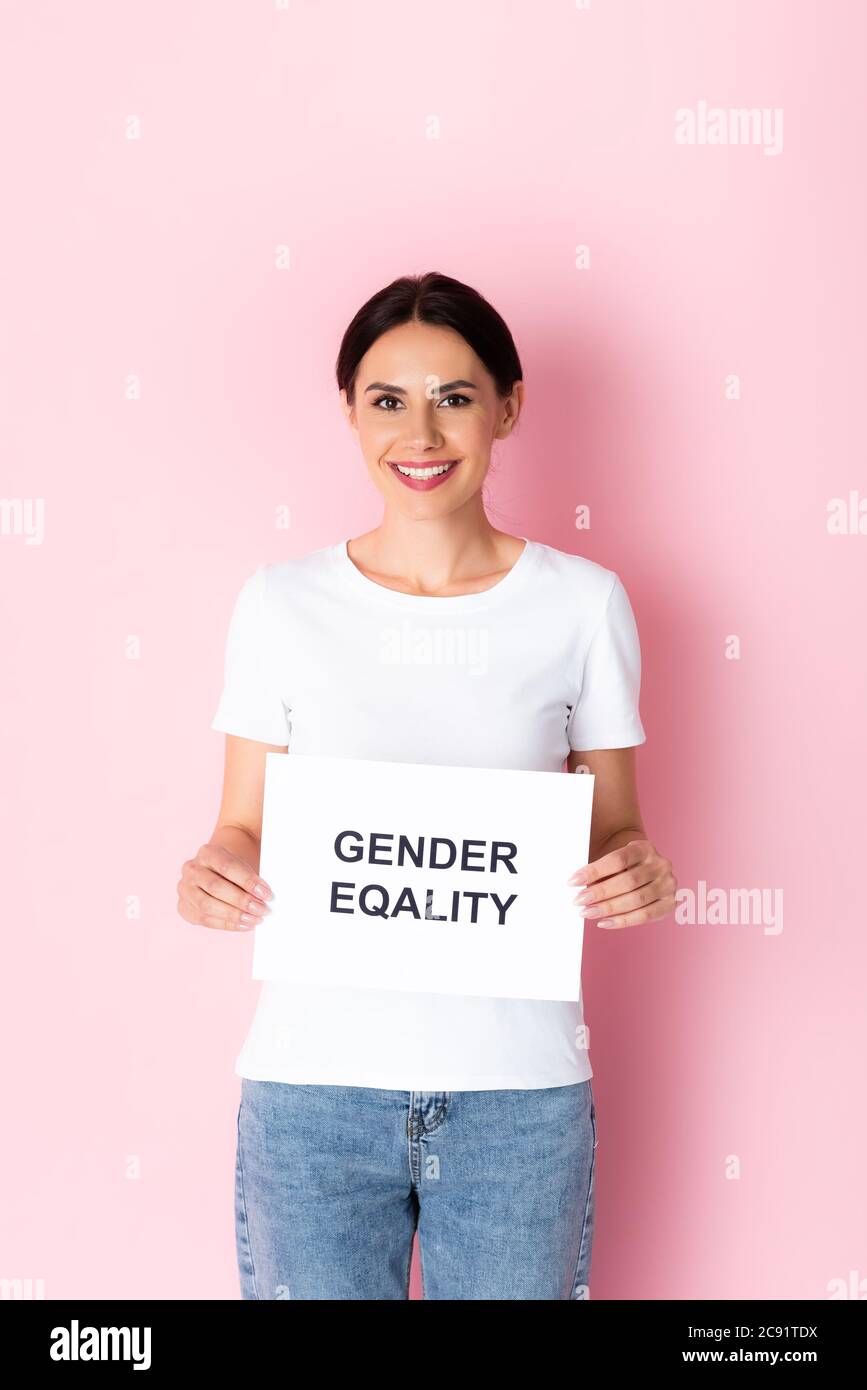 happy woman in white t-shirt holding placard with gender equality ...